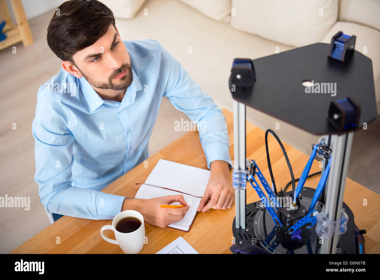 Handsome concentrated man using 3d printer Stock Photo - Alamy