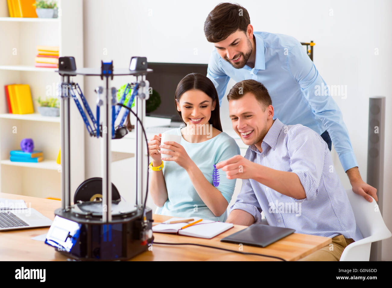 Positive student holding fish printed on 3d printer Stock Photo - Alamy