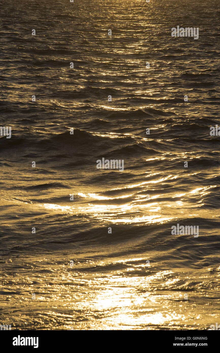 Calm waves reflect sunset on sea surface, ocean water at summer ...