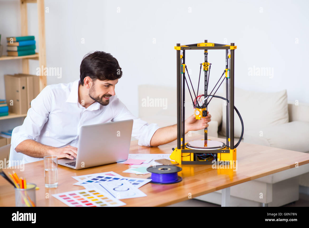Cheerful handsome man using 3d printer Stock Photo - Alamy