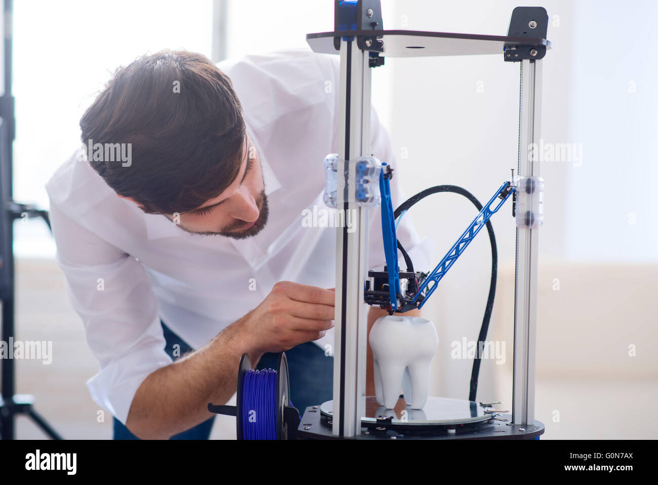 Pleasant man using 3d printer Stock Photo - Alamy