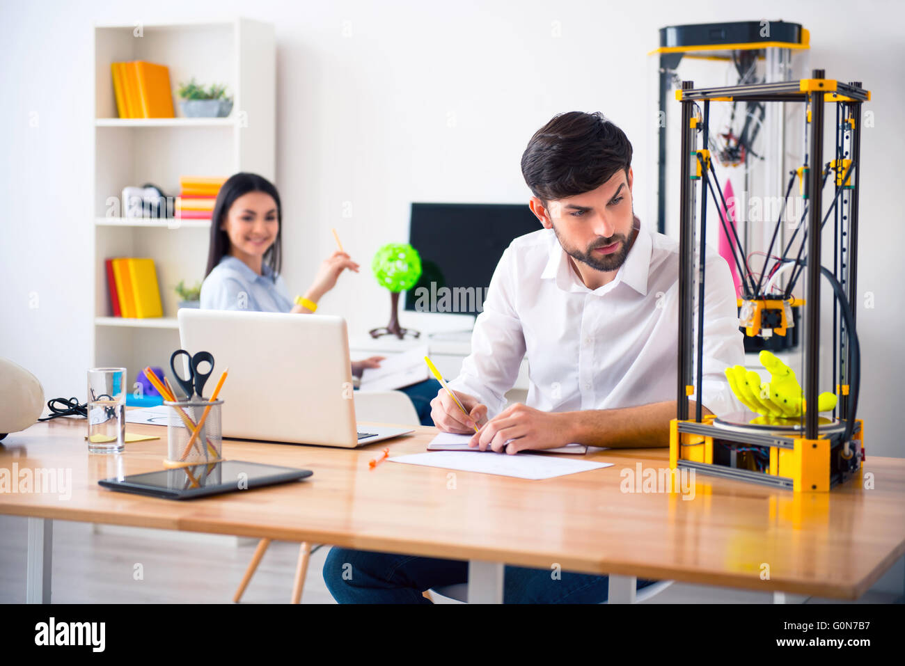 Pleasant man using 3d printer Stock Photo - Alamy