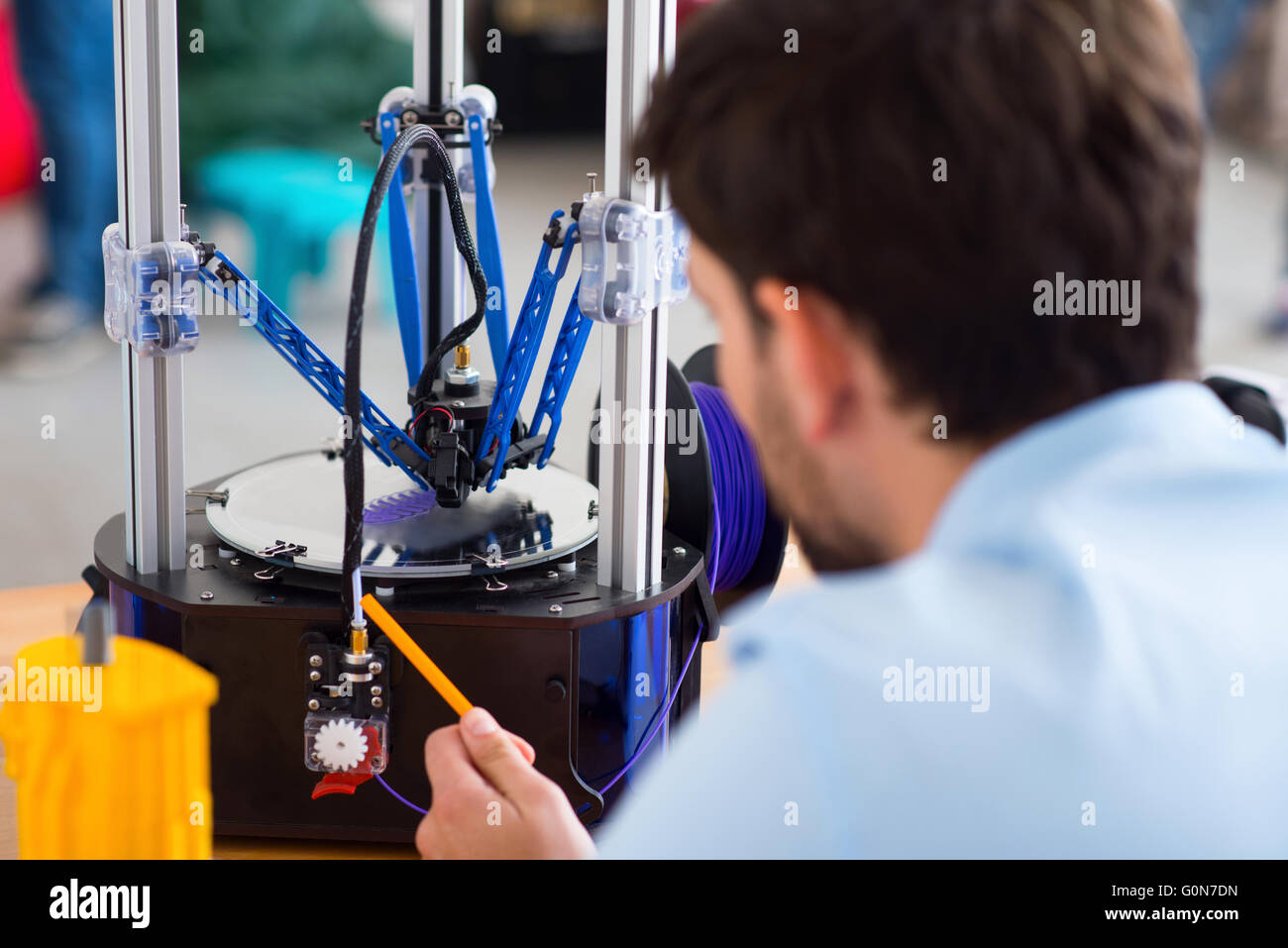 Pleasant man working with 3d printer Stock Photo - Alamy