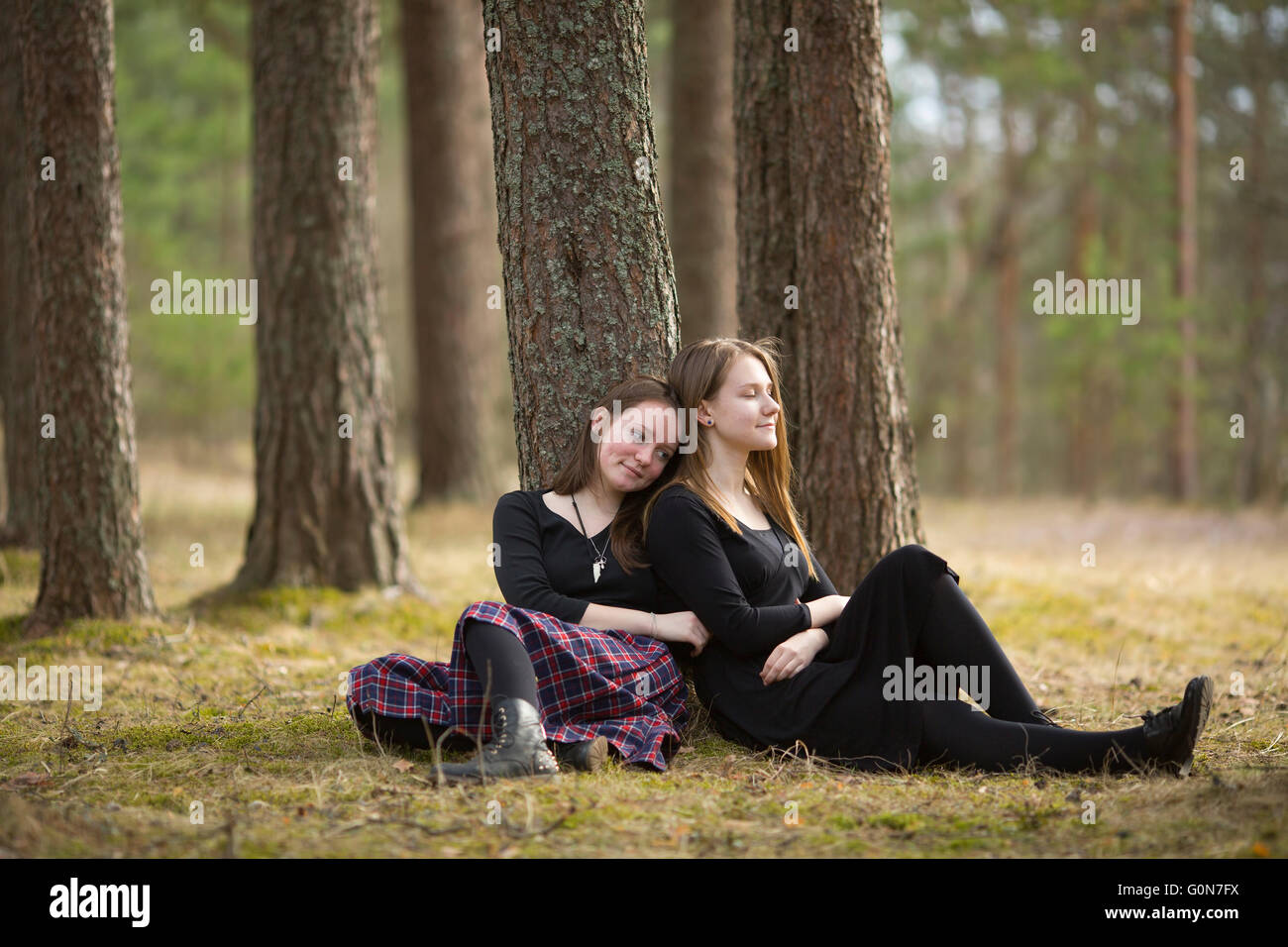 Teenage girls best friends sitting in the forest Stock Photo - Alamy