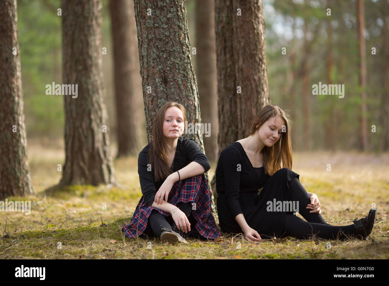 Teenage girls best friends sitting in the forest Stock Photo - Alamy