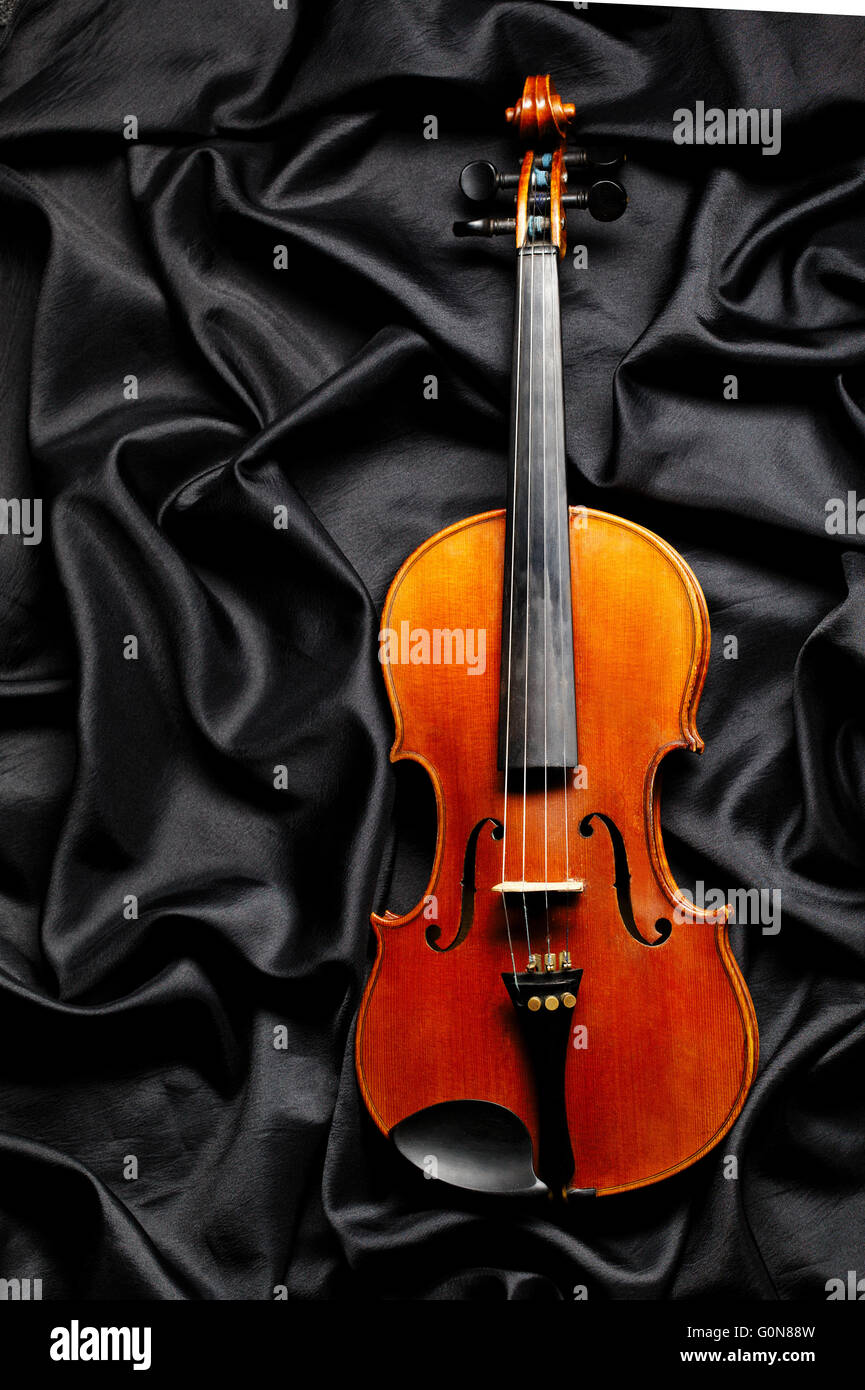 aged violin on dark fabric texture Stock Photo - Alamy