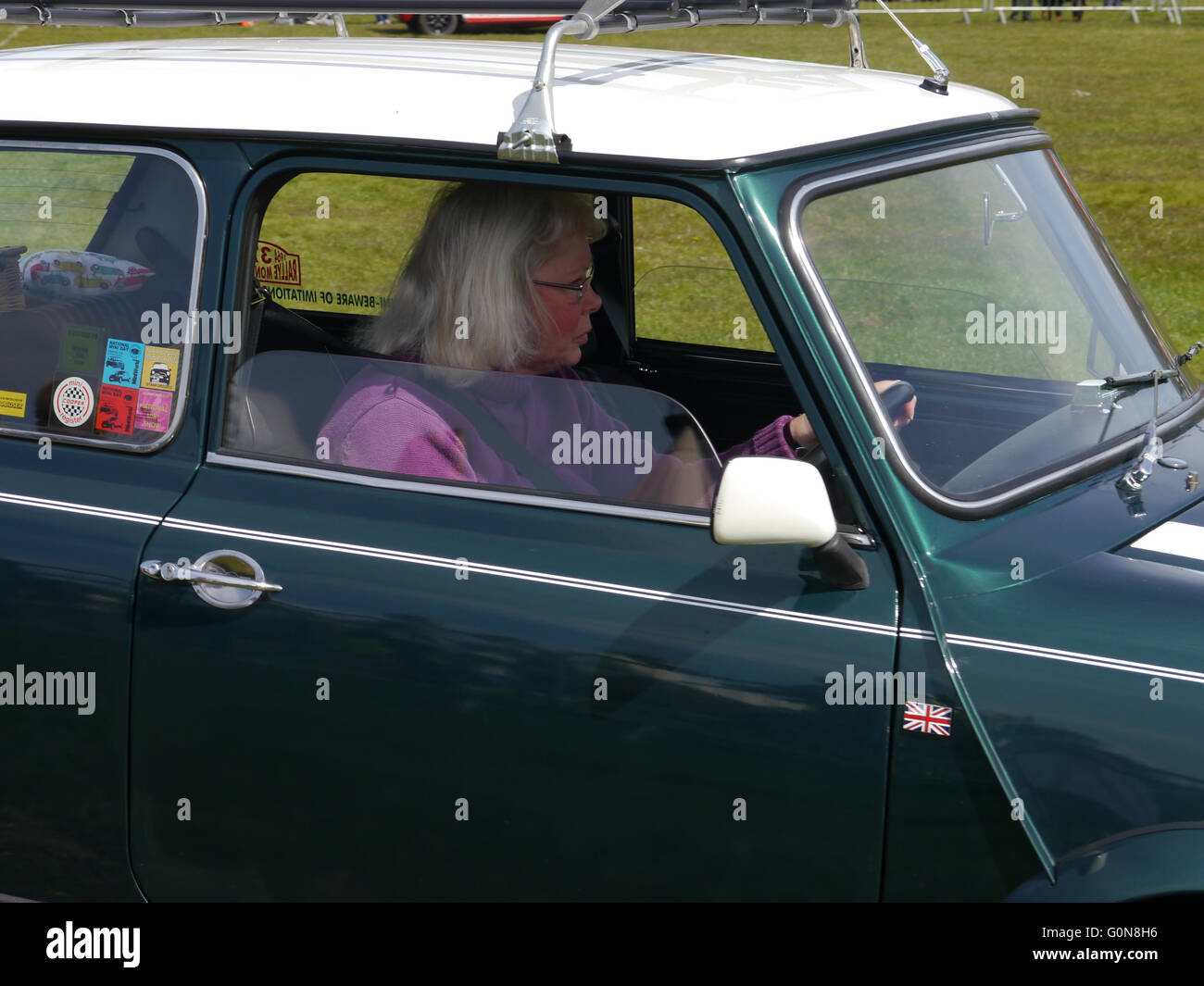 A Senior lady driving a classic mini motor car Stock Photo - Alamy