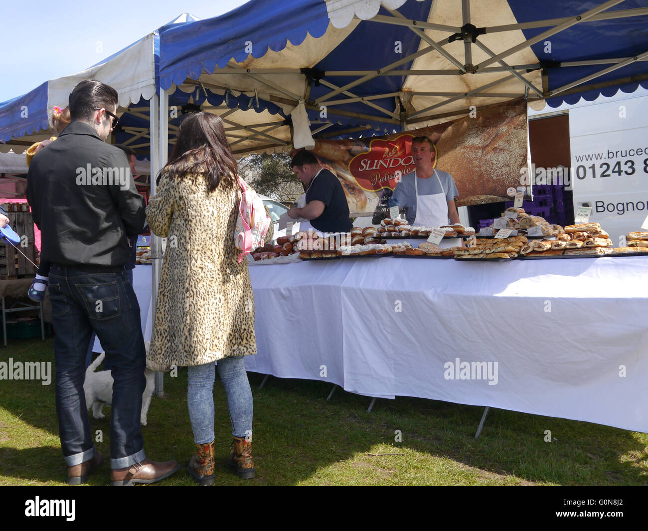 Customers buying sweet treats and cakes from a food stall Stock Photo ...