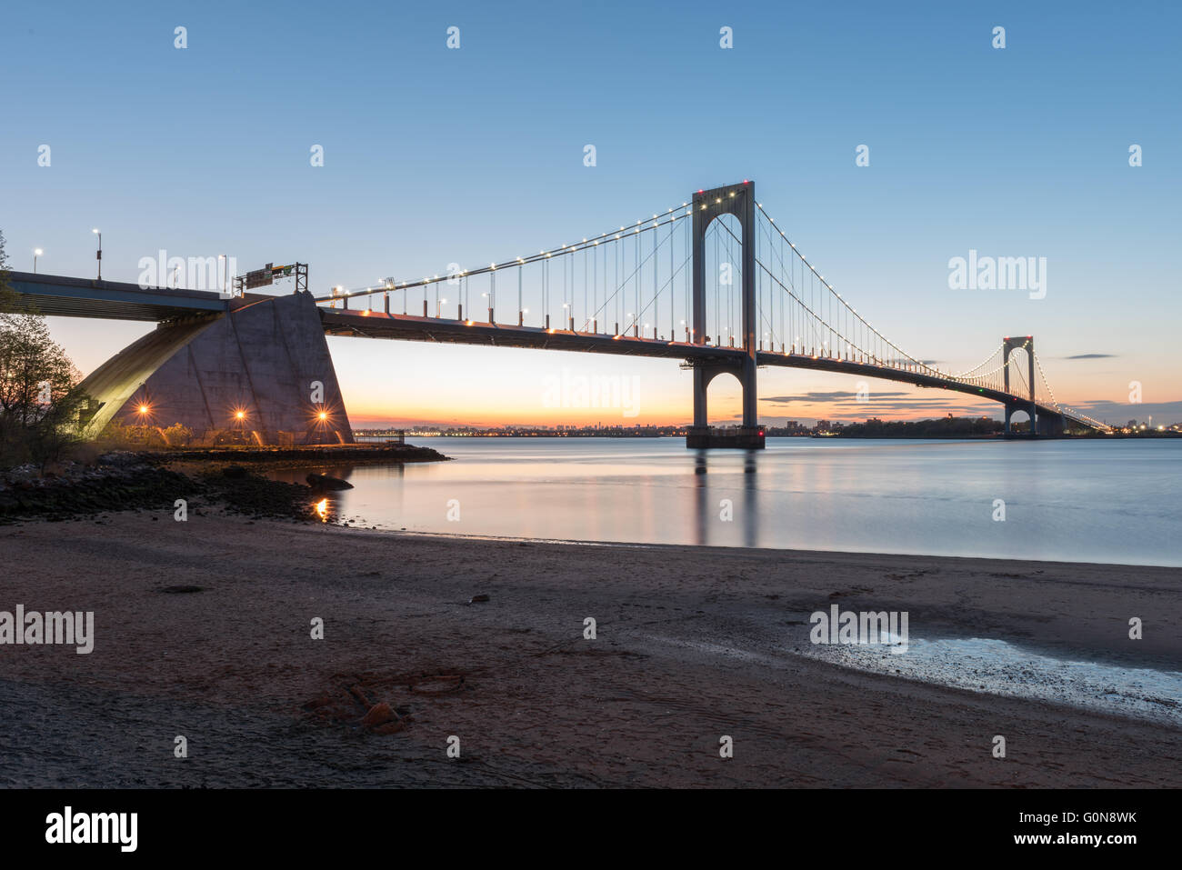 The Bronx-Whitestone Bridge reflecting on the East River at night in ...