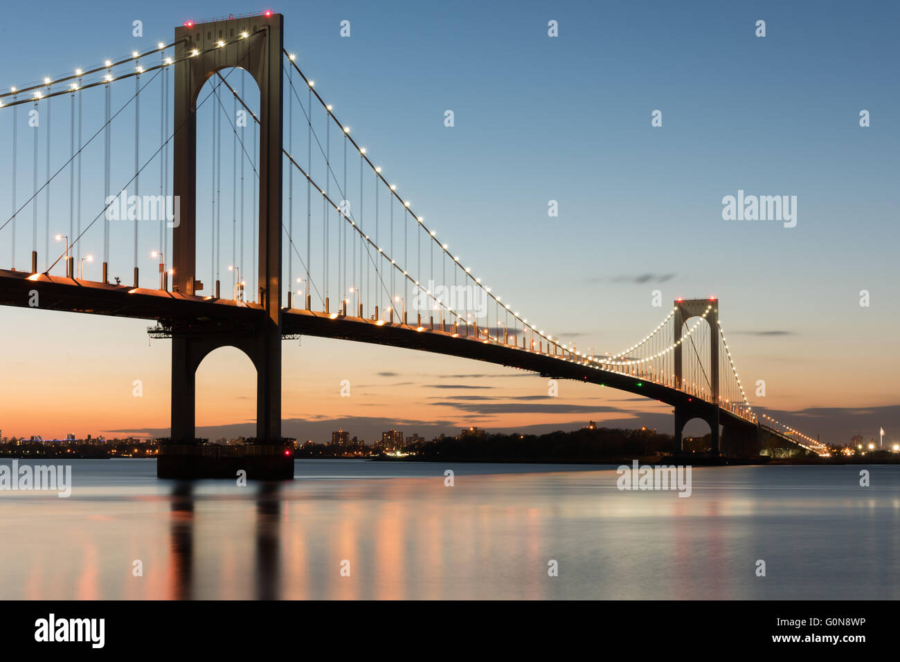 The Bronx-Whitestone Bridge reflecting on the East River at night in ...