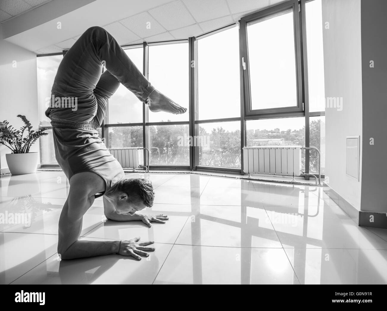 Athletic muscular young man working out, yoga Stock Photo - Alamy