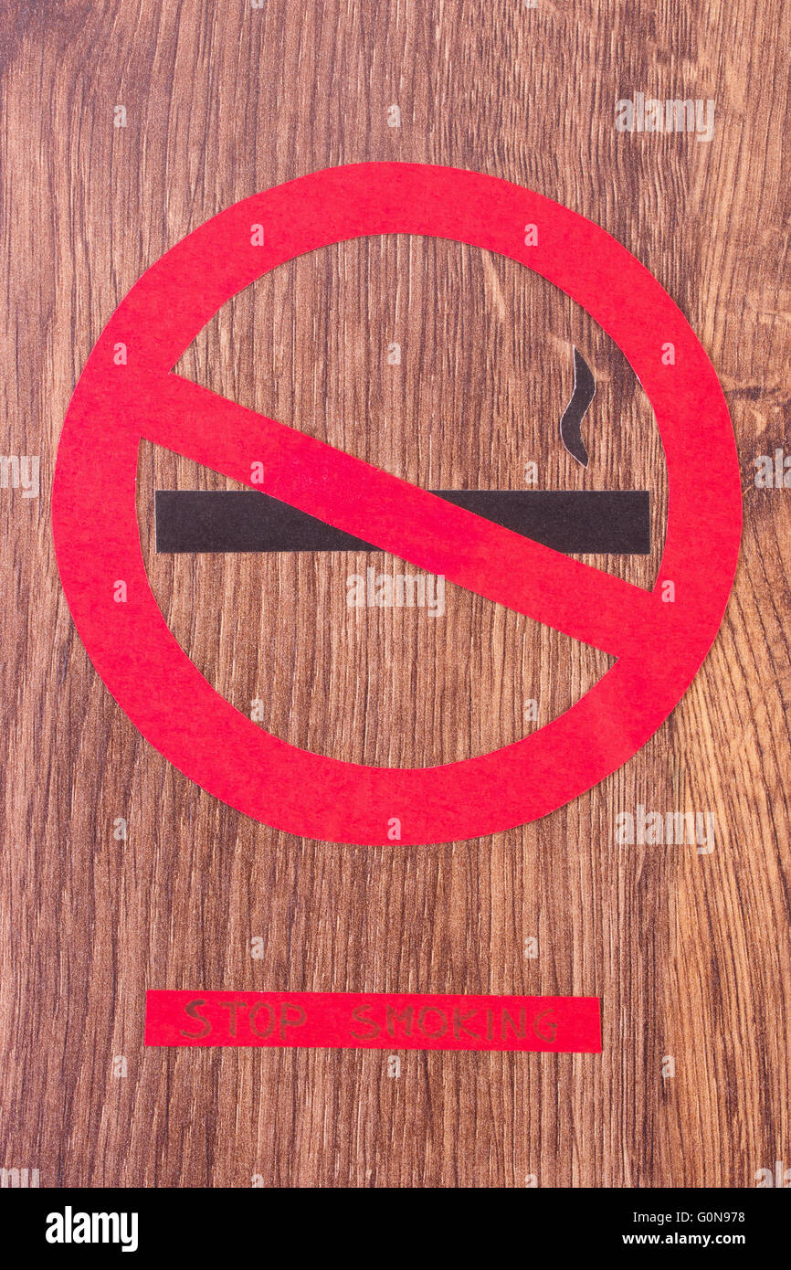 Red no smoking sign made of paper with inscription stop smoking, symbol ...