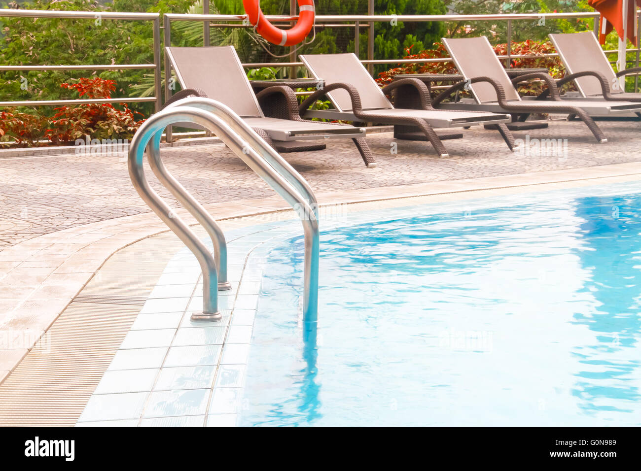 Ladder by The pool of a Common Swimming Pool Stock Photo - Alamy