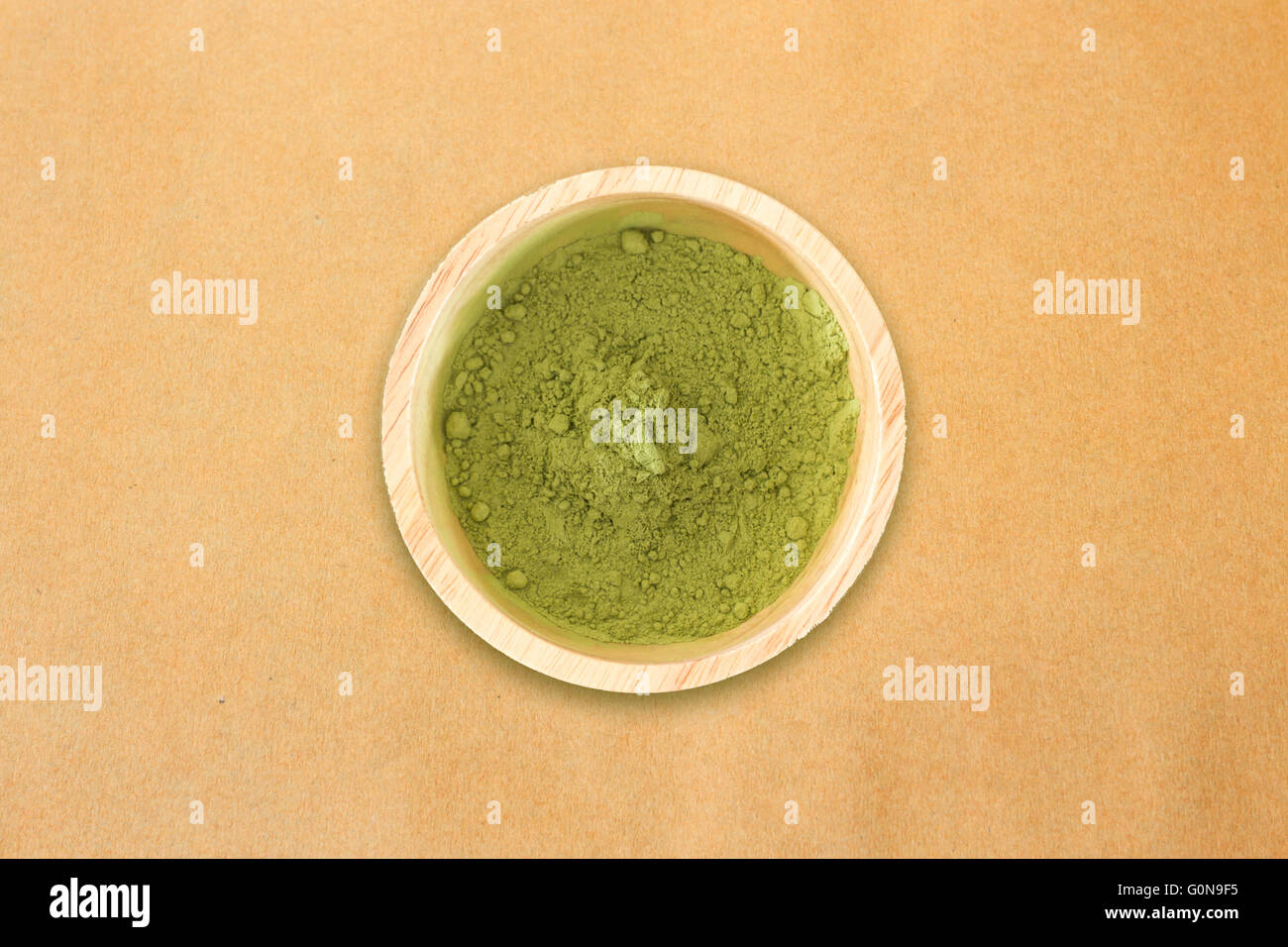Wooden bowl of green tea powder on brown paper background, stock photo ...