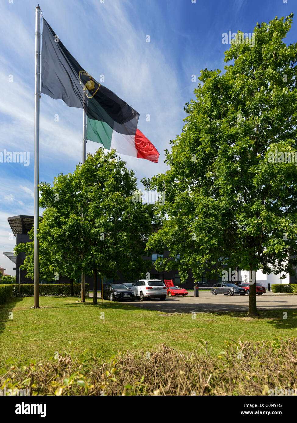 Flags in front of the Lamborghini factory with the factory logo and the ...