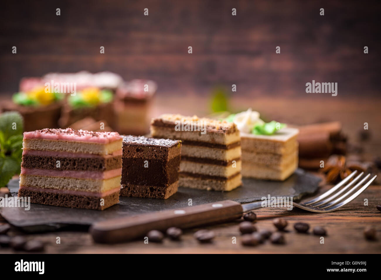 Different sort of small square sweet cakes Stock Photo - Alamy