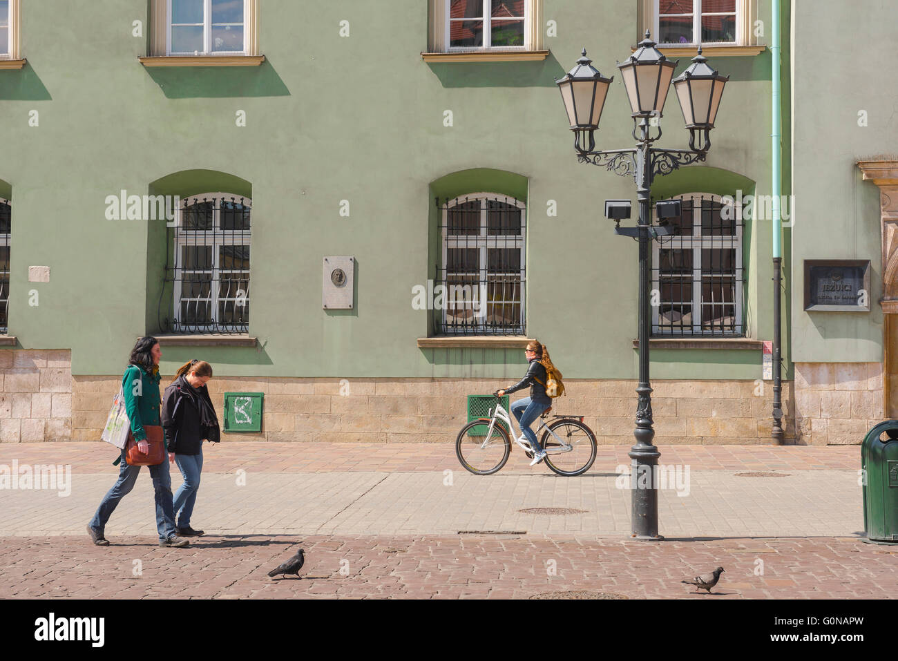Little Market Square Krakow, view of people passing by a colourful ...
