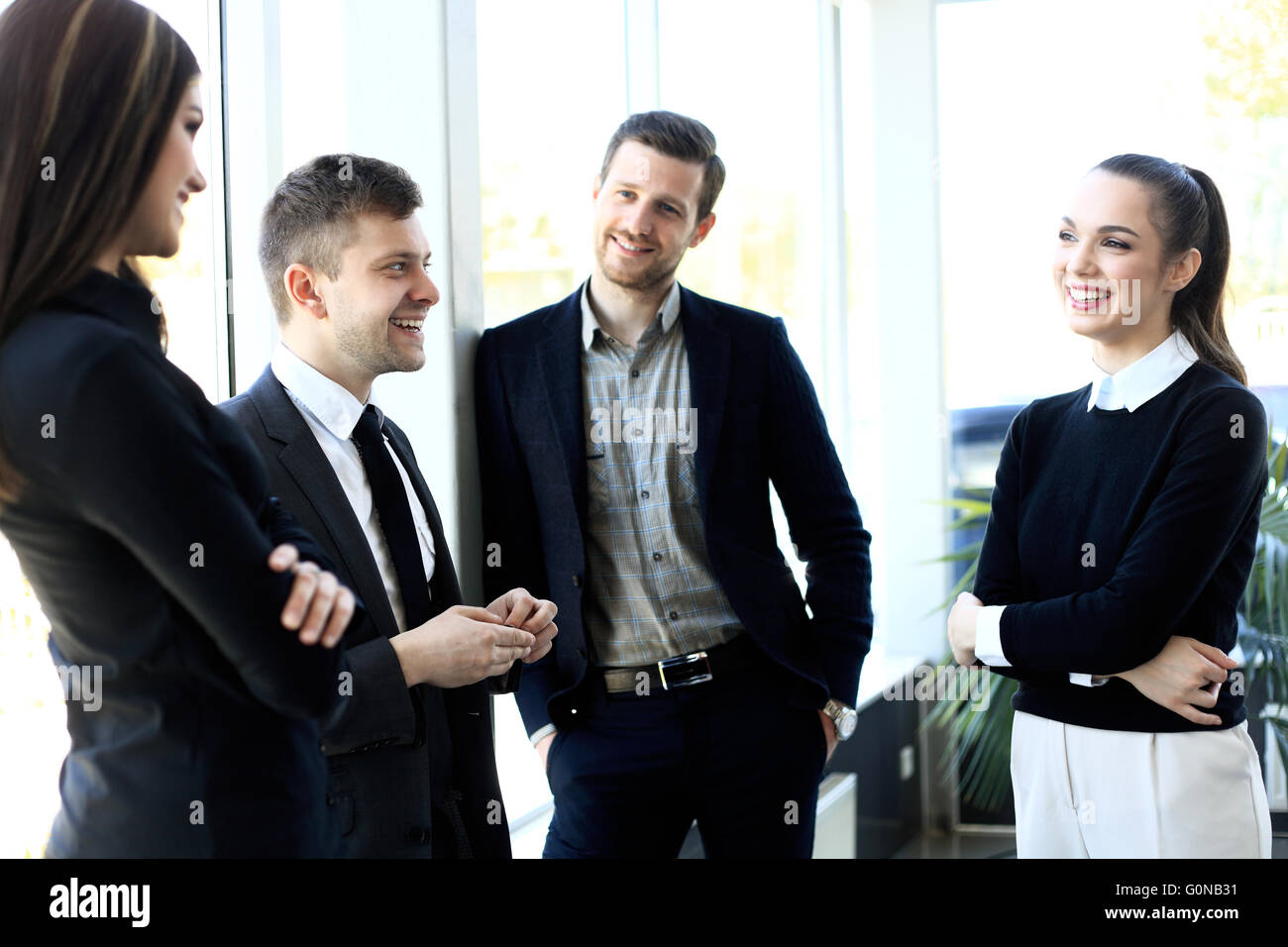 Happy smiling business team in office Stock Photo - Alamy