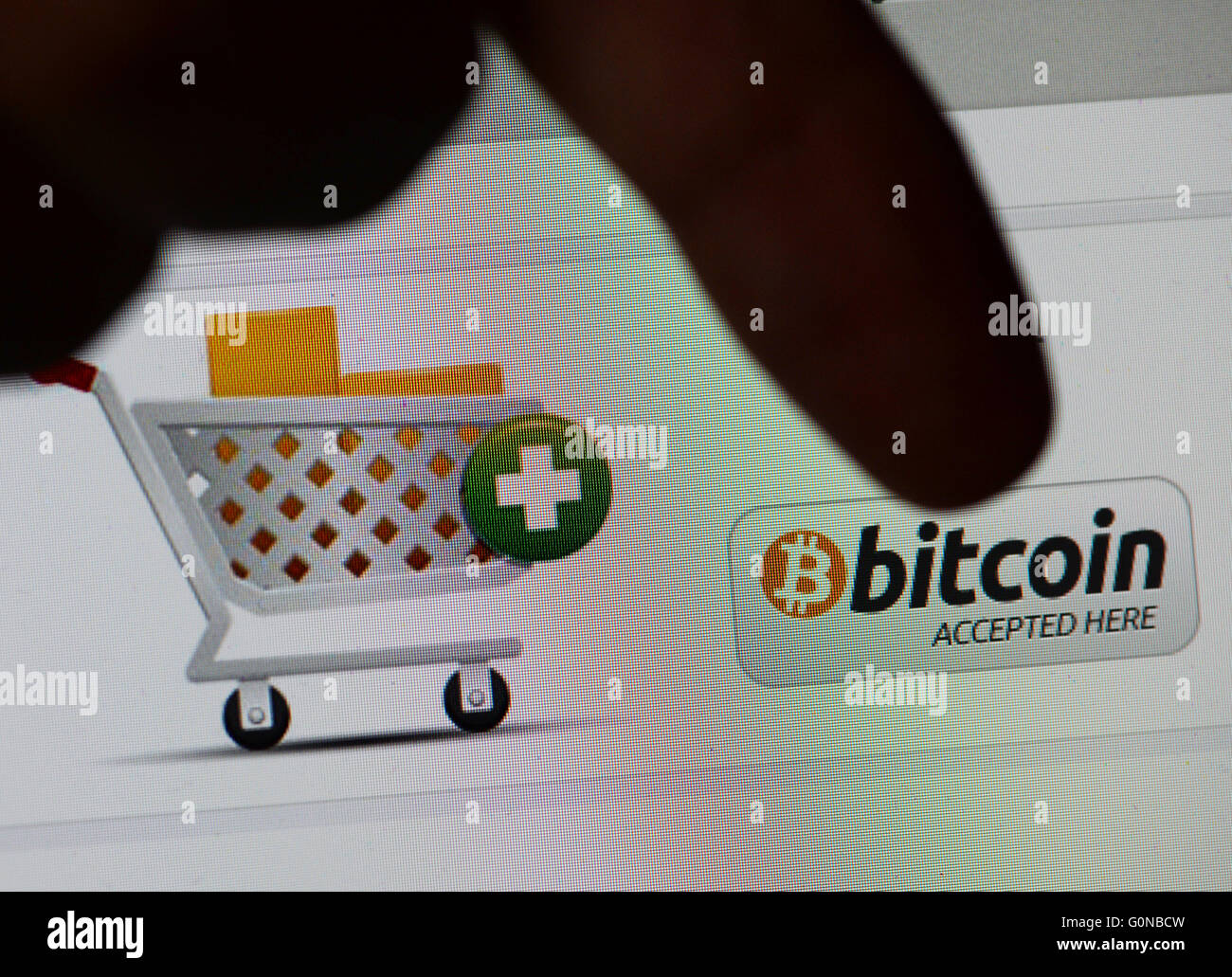 (ILLUSTRATION) A finger points to the logo of digital currency Bitcoin ...