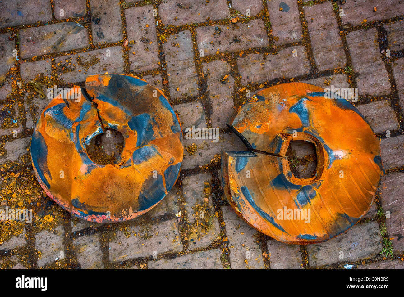 rusty en blue floaters for fishing net on quay brick floor Stock Photo ...