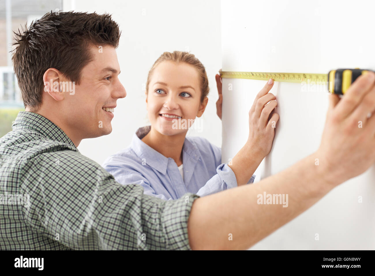 Male measuring wall tape hi-res stock photography and images - Alamy