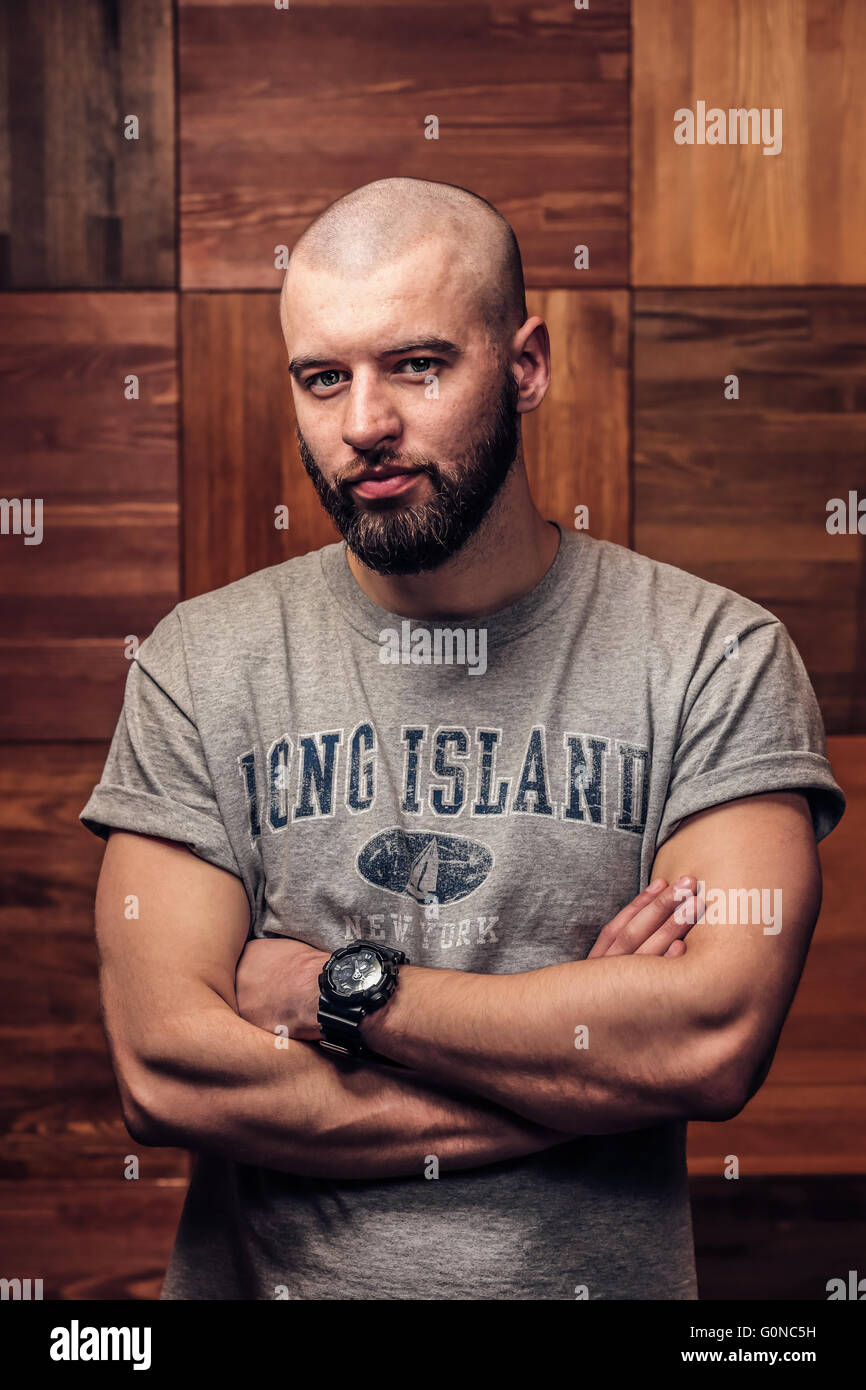 Serious bald bearded man on wooden texture Stock Photo - Alamy