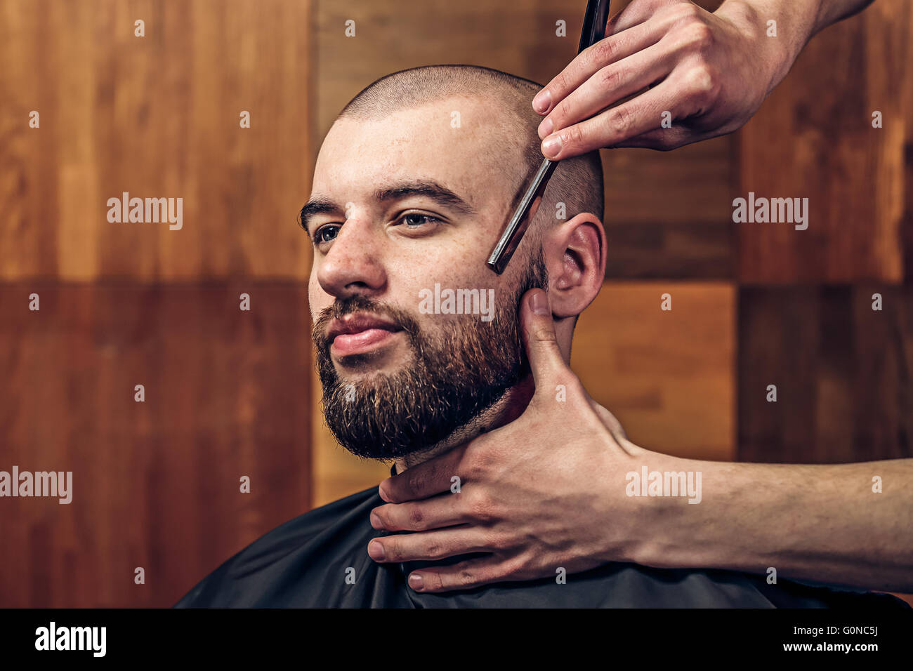 Bearded man getting shaved with straight edge razor Stock Photo - Alamy
