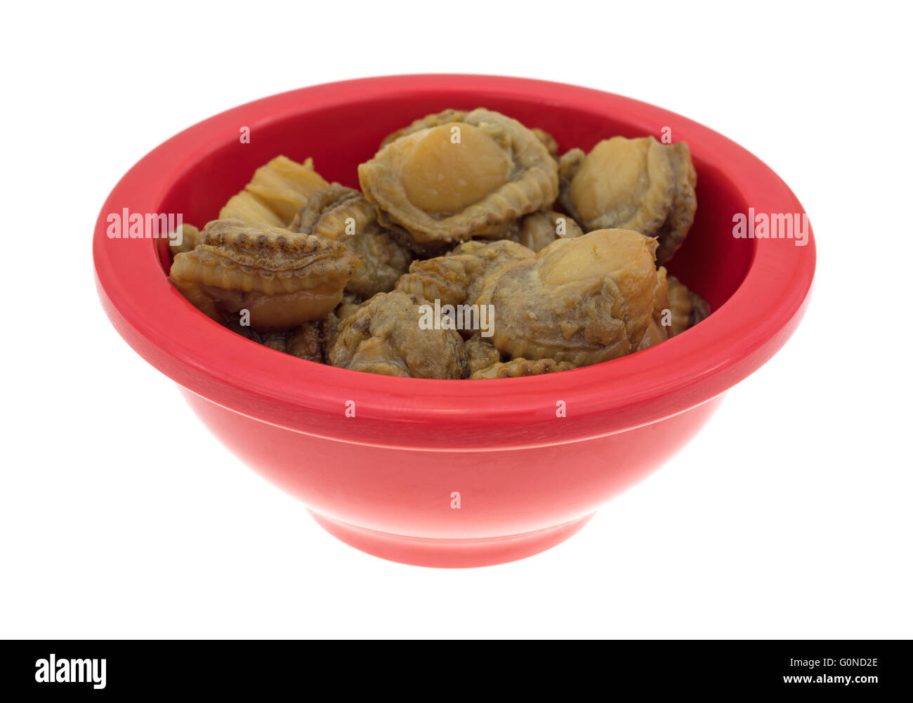 Side view of a small bowl of smoked scallops isolated on a white ...