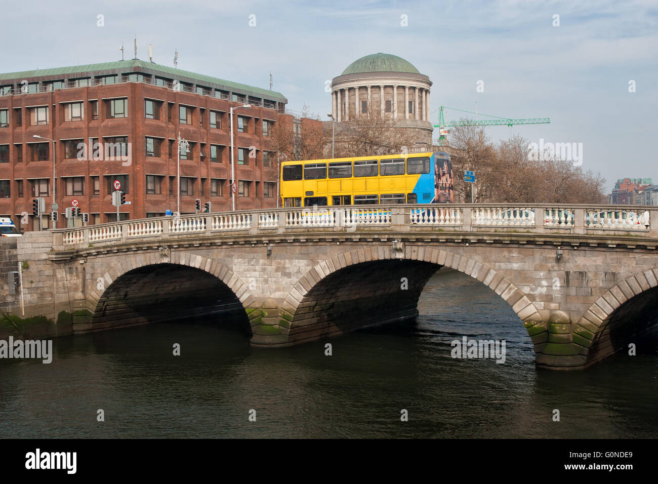 Ireland, city of Dublin, yellow tour bus on Father Mathew Bridge over ...