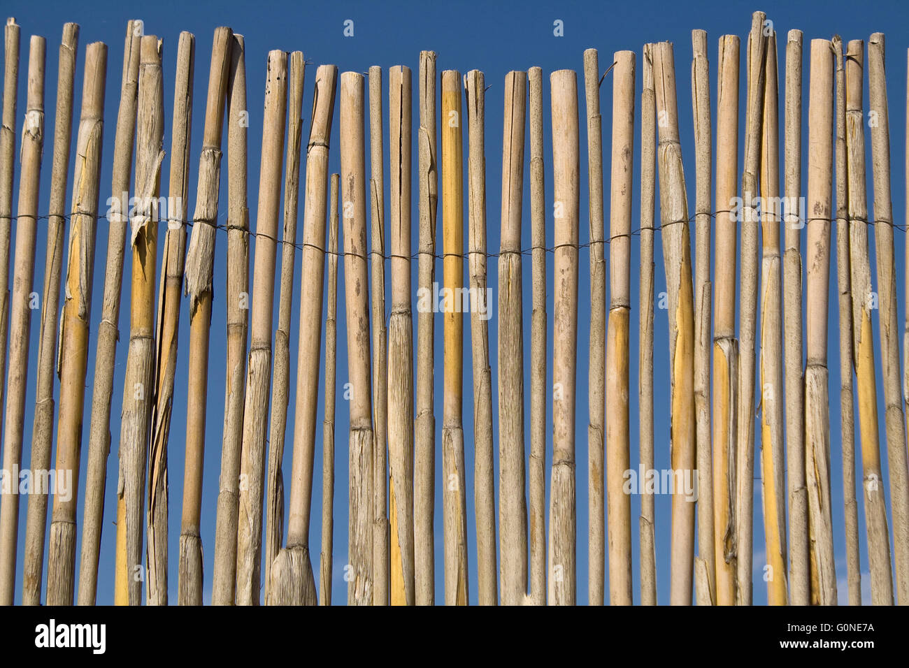 Cane fence texture over blue sky Stock Photo - Alamy