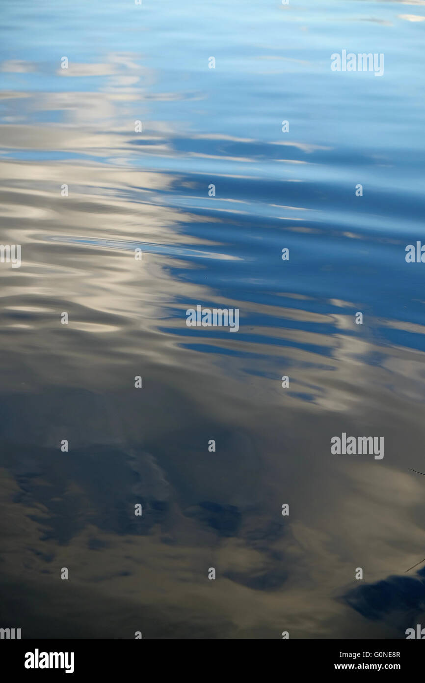 blue sky and white clouds reflected in water with ripples Stock Photo ...