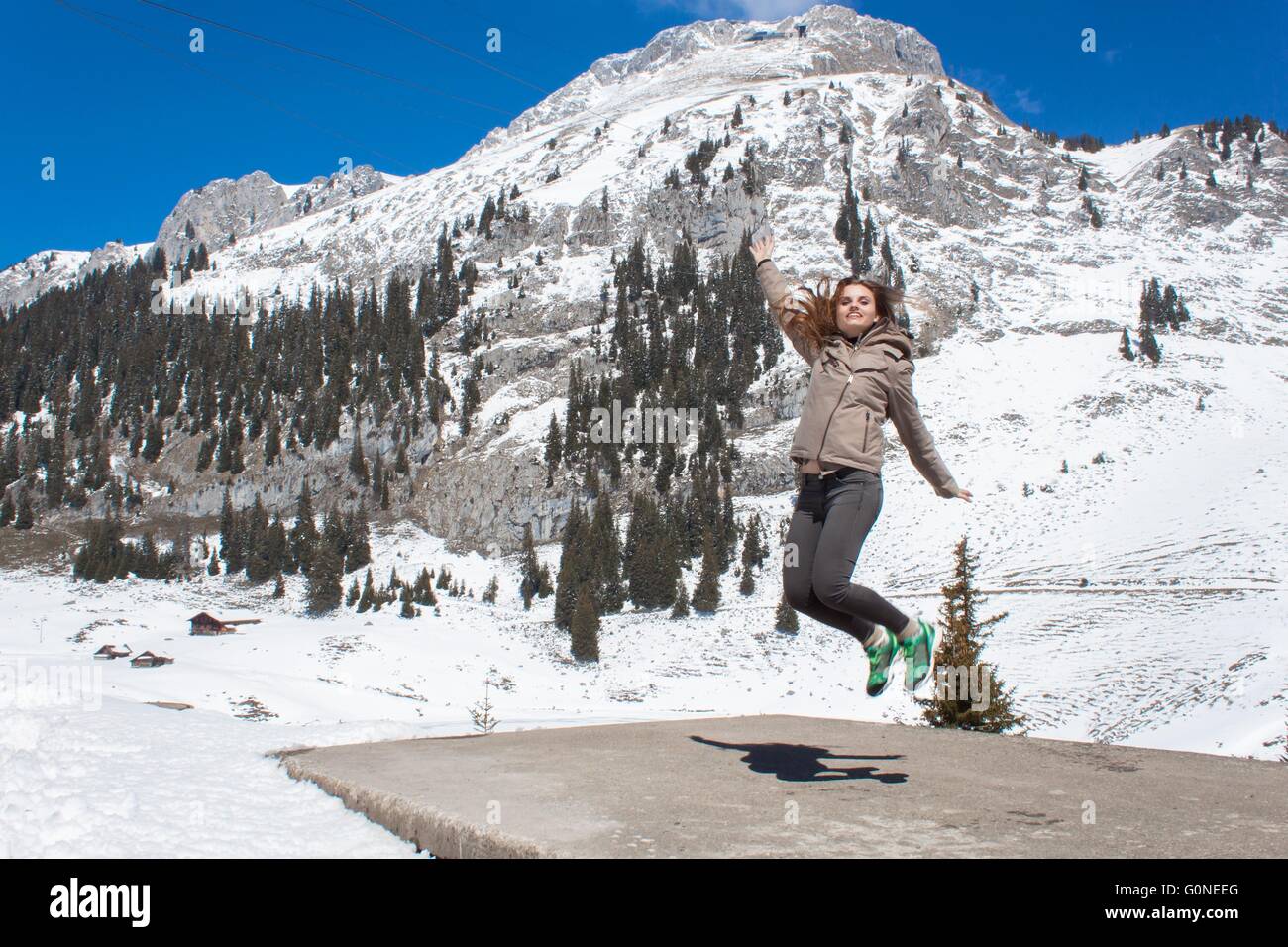 A young girl on vacation in the mountains. Happy beautiful girl in the ...