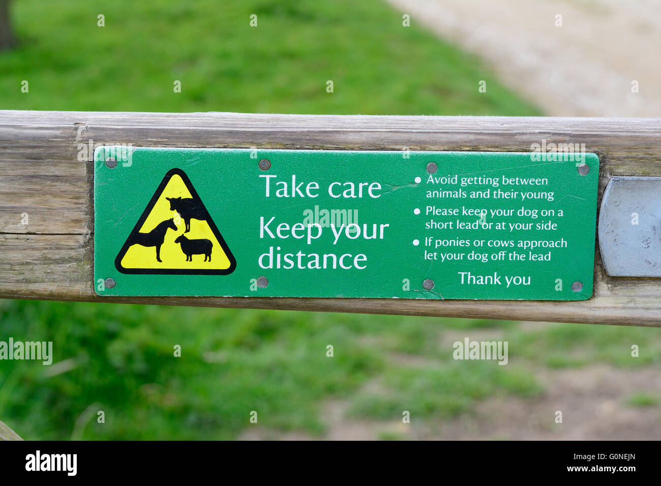 Rural Warning sign "Keep your distance" on a gate to a farmers field ...