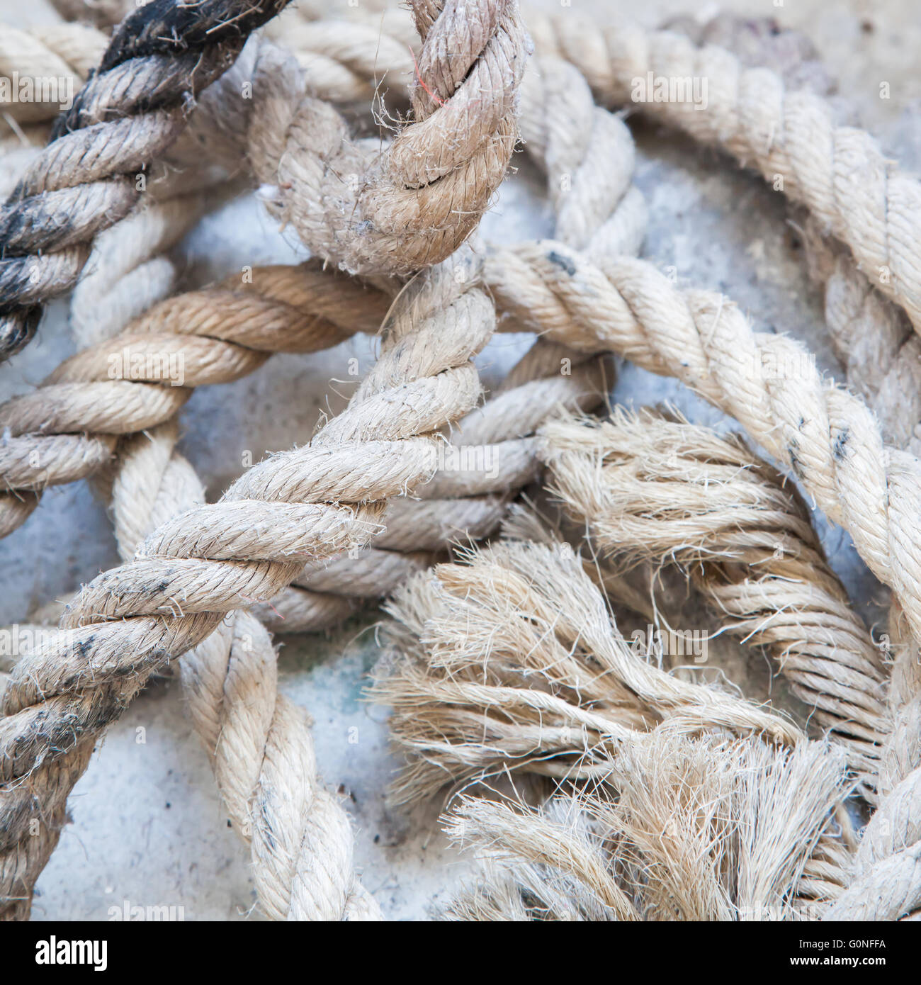 Knotted boat ropes over a sea boat Stock Photo - Alamy