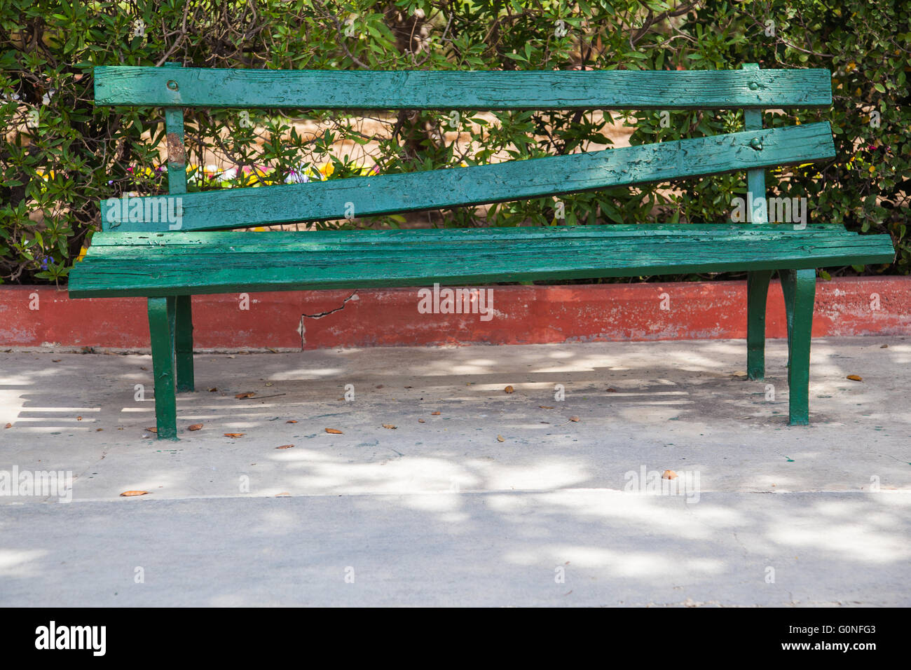 Badly fixed bench made with gree wood panels Stock Photo - Alamy