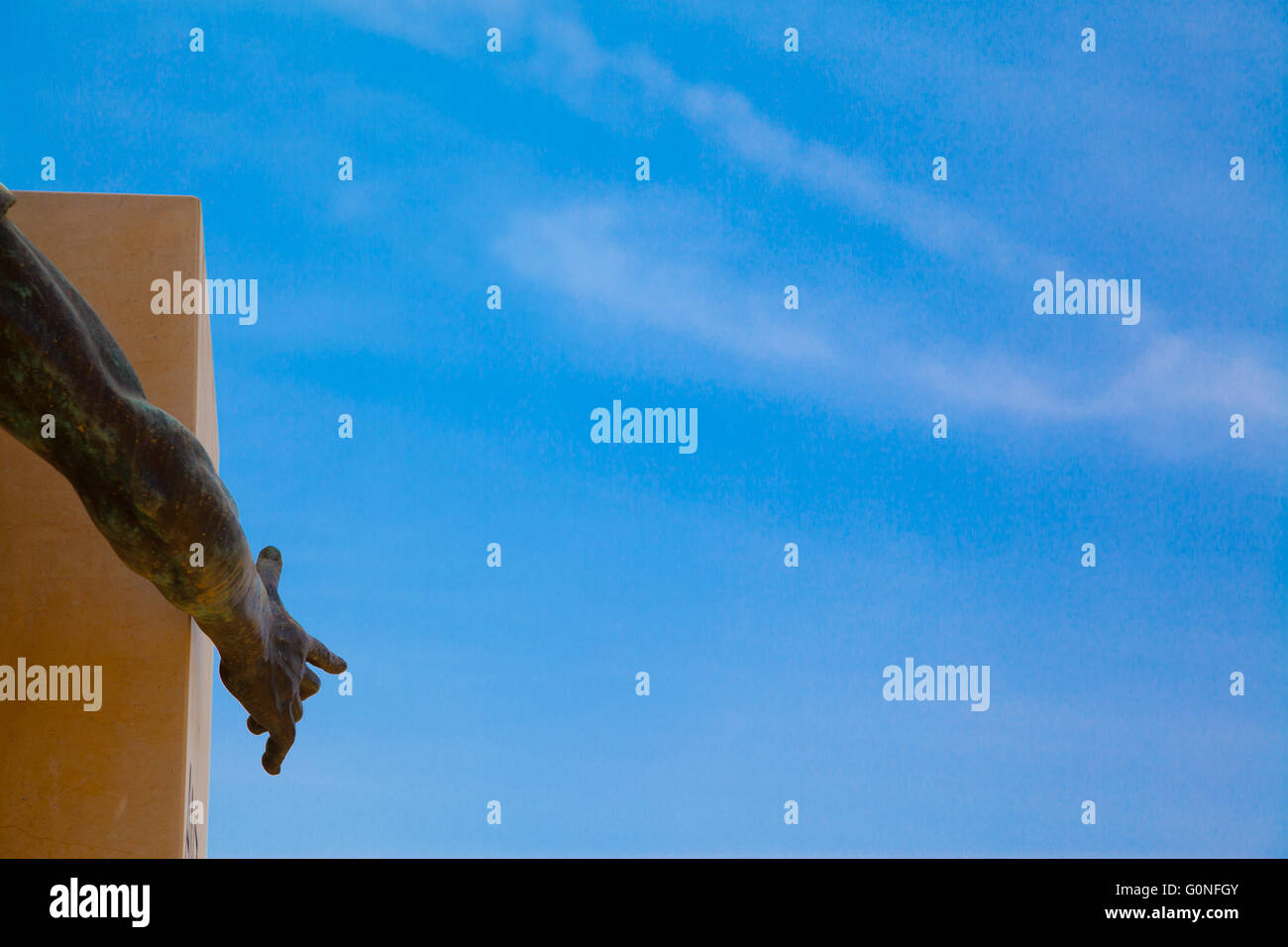 A bronze hand pointing a blue summer sky Stock Photo - Alamy