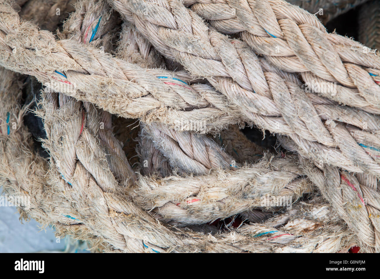 Hanged weathered boat ropes on a blue sea Stock Photo - Alamy