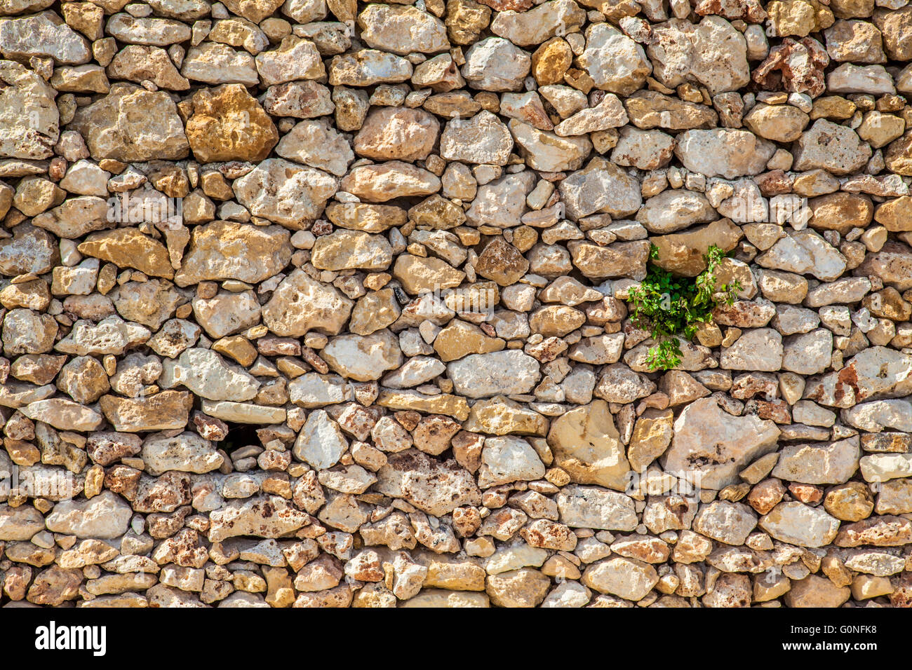Handmade wall with small different colured stones Stock Photo - Alamy