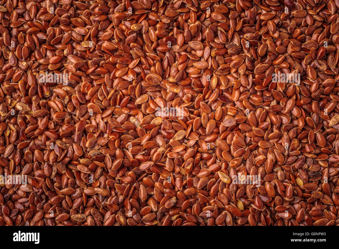 Healthy diet organic nutrition. Brown raw flax seeds linseed as natural food background Stock ...