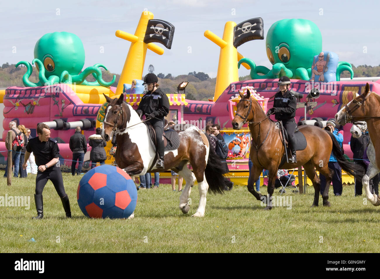 Mounted police demonstrating the use of a crowd control training ball ...