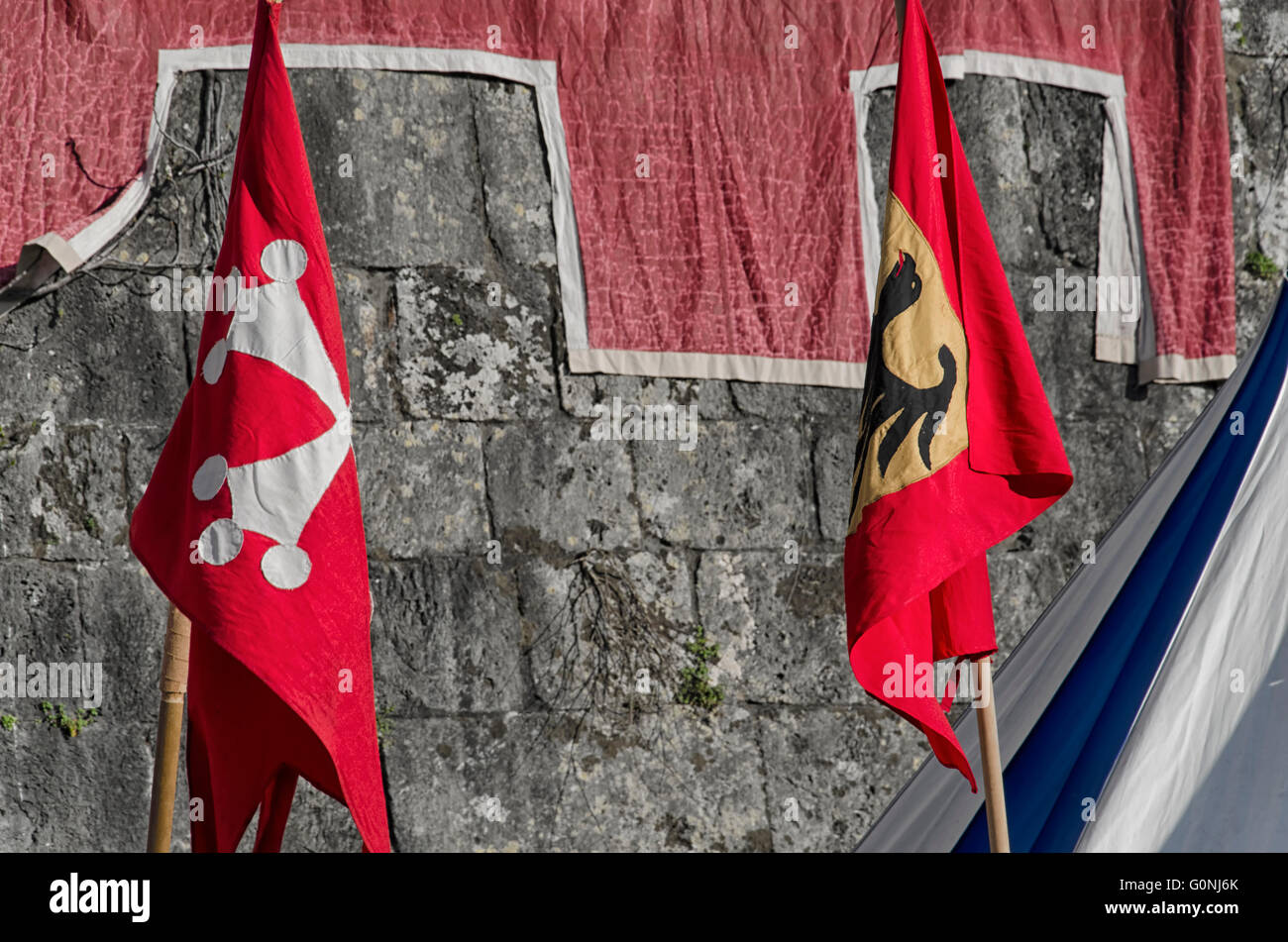 Red ensigns in medieval fair in Pisa Stock Photo - Alamy