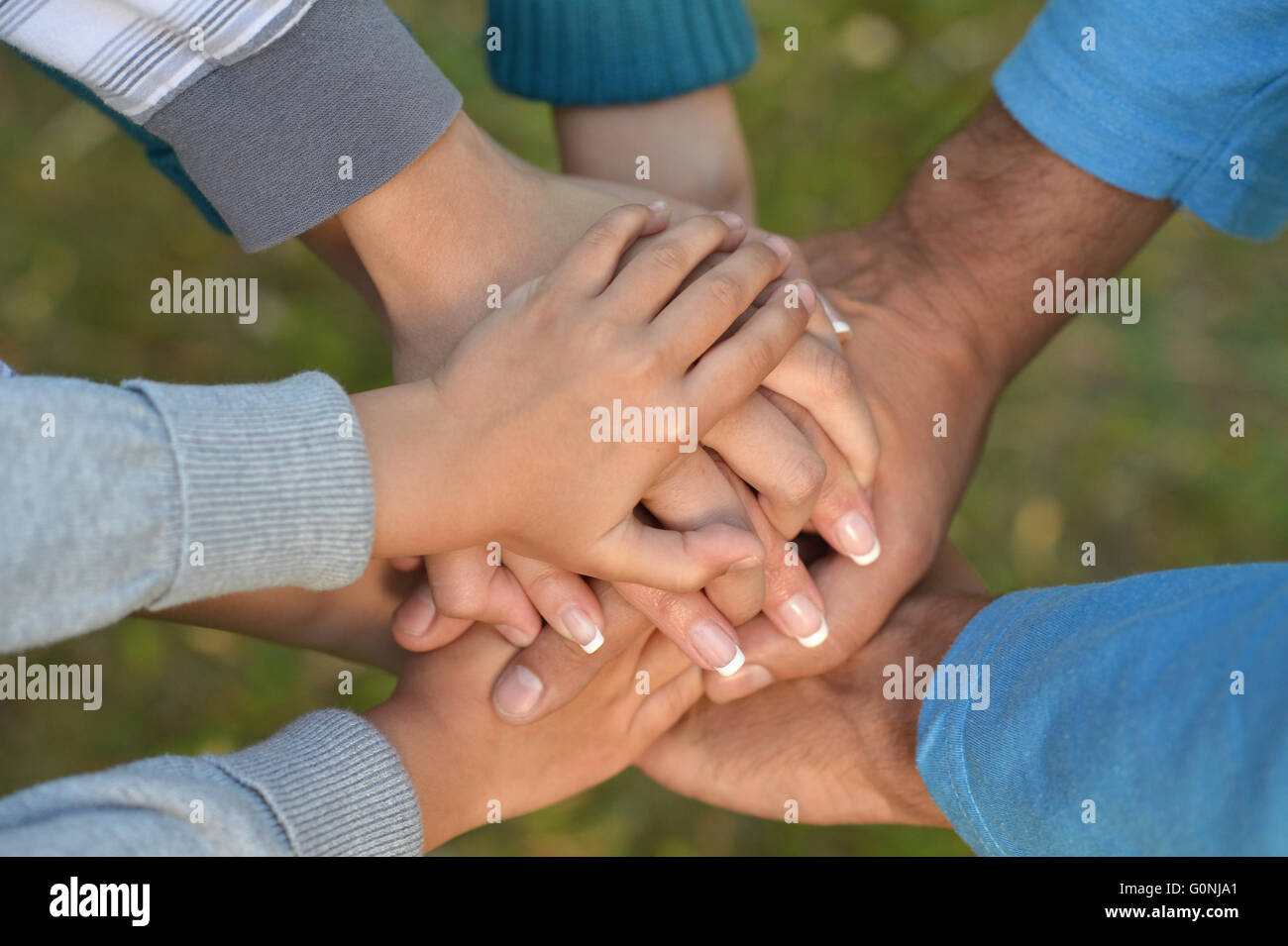 Hands together on background Stock Photo - Alamy