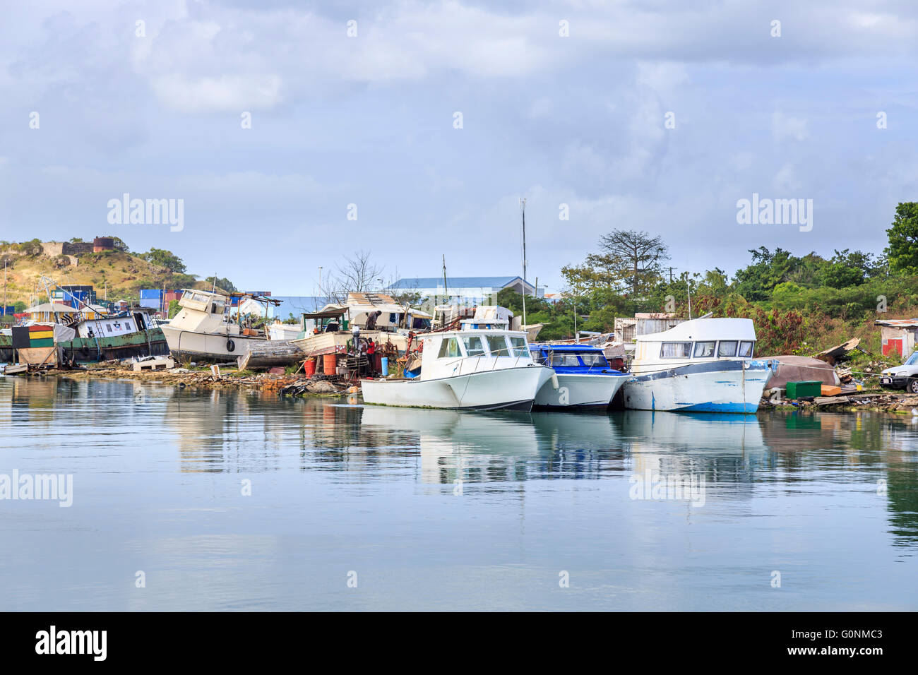 Local old working boats afloat and beached in a boatyard in the harbour ...