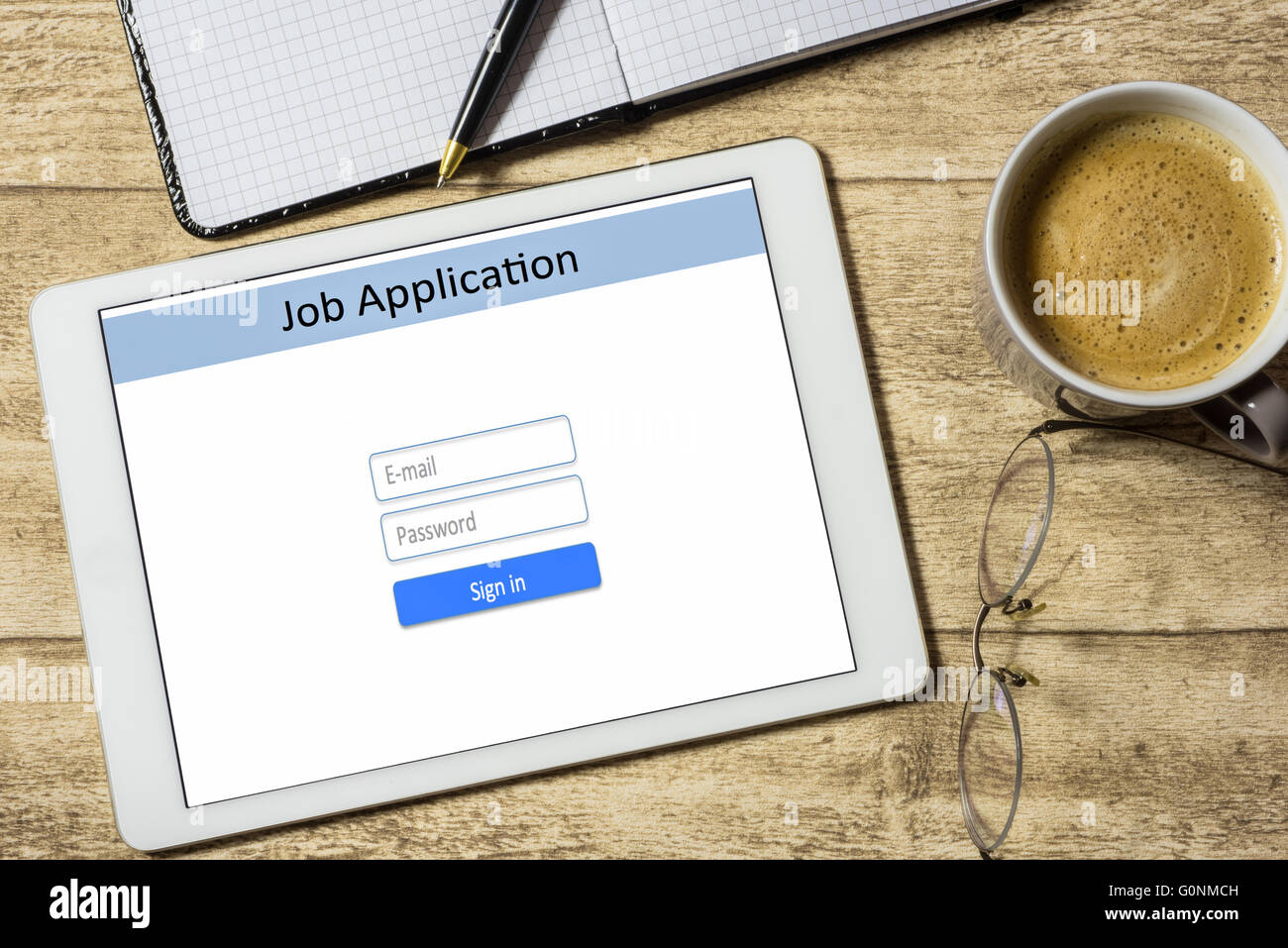 Tablet with Job Application sign in on wooden table Stock Photo - Alamy