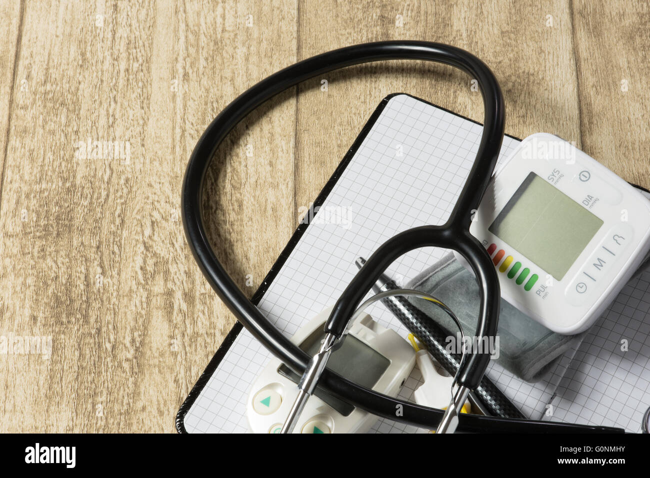 stethoskope on wooden desk with blood pressure measurement copy space ...