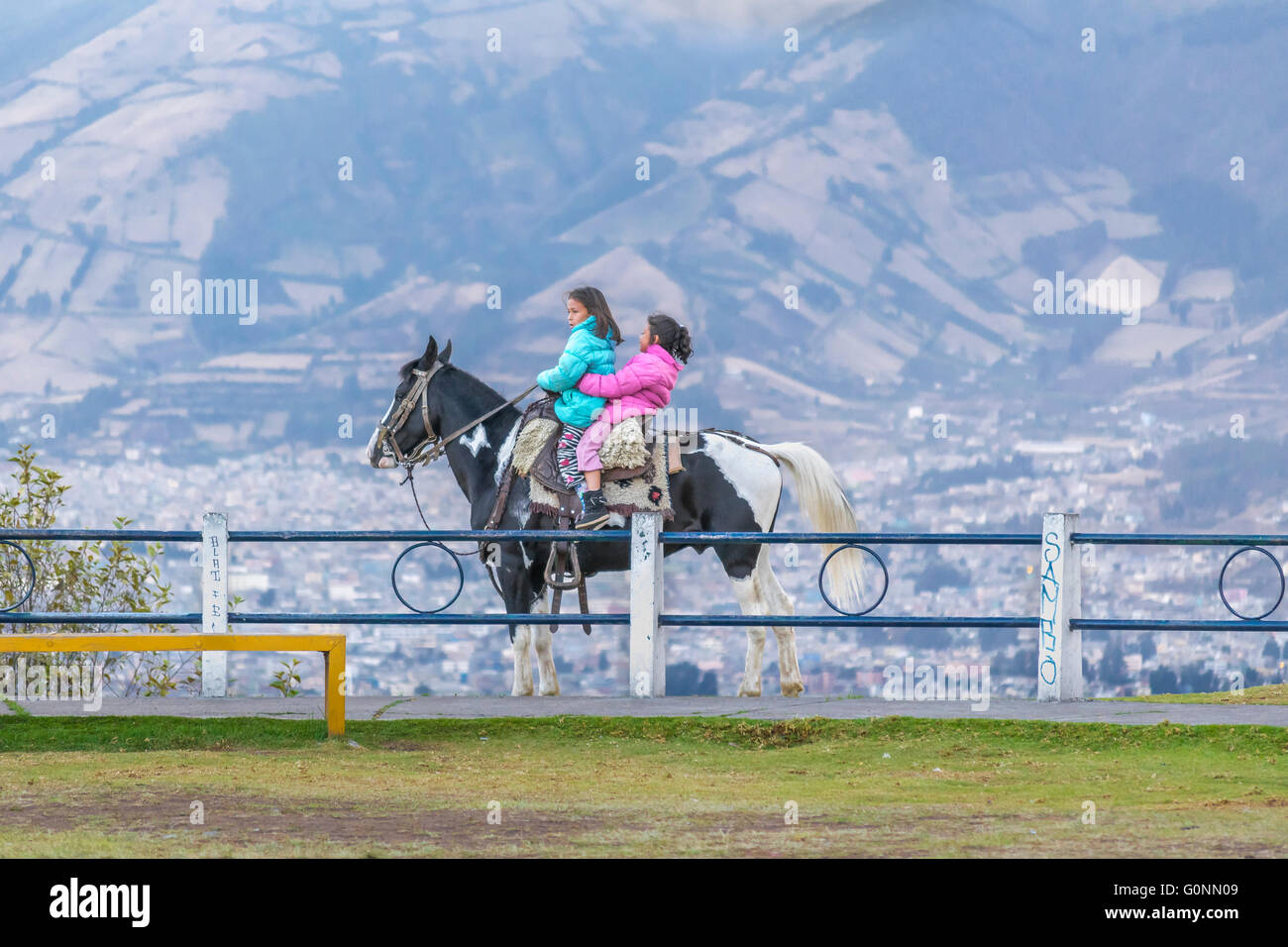 QUITO, ECUADOR, OCTOBER - 2015 - Two indigenous ecuadorian girls riding ...