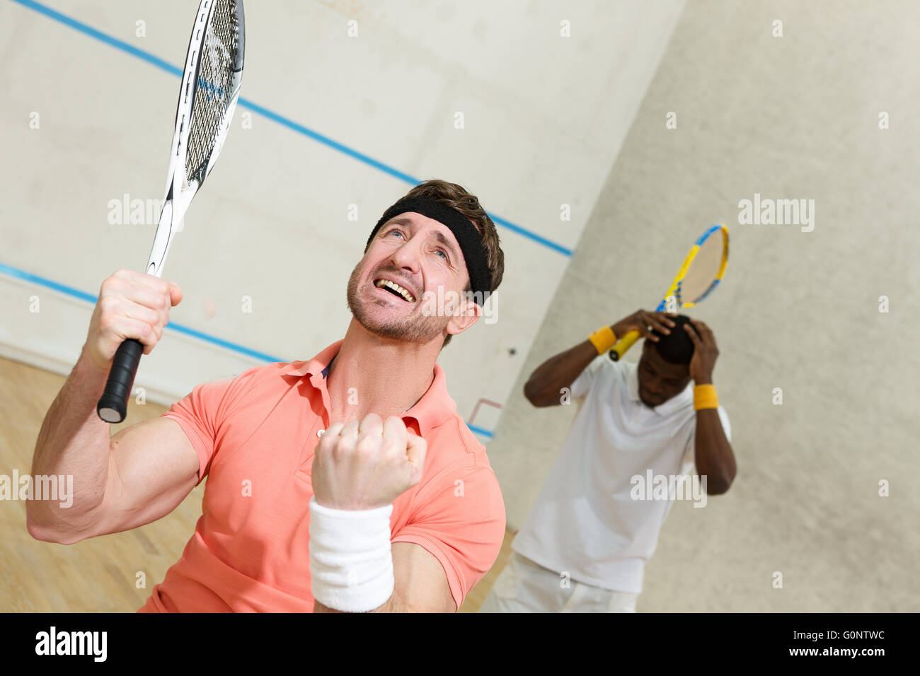 Men playing squash Stock Photo - Alamy