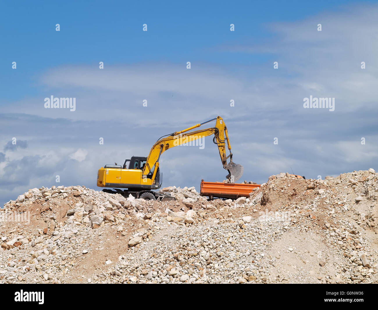 excavator loading tipper truck on construction site Stock Photo - Alamy