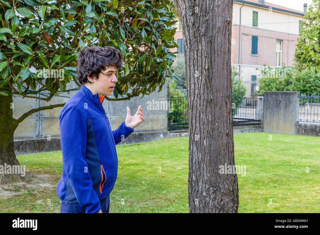 young boy debating with himself in garden Stock Photo - Alamy