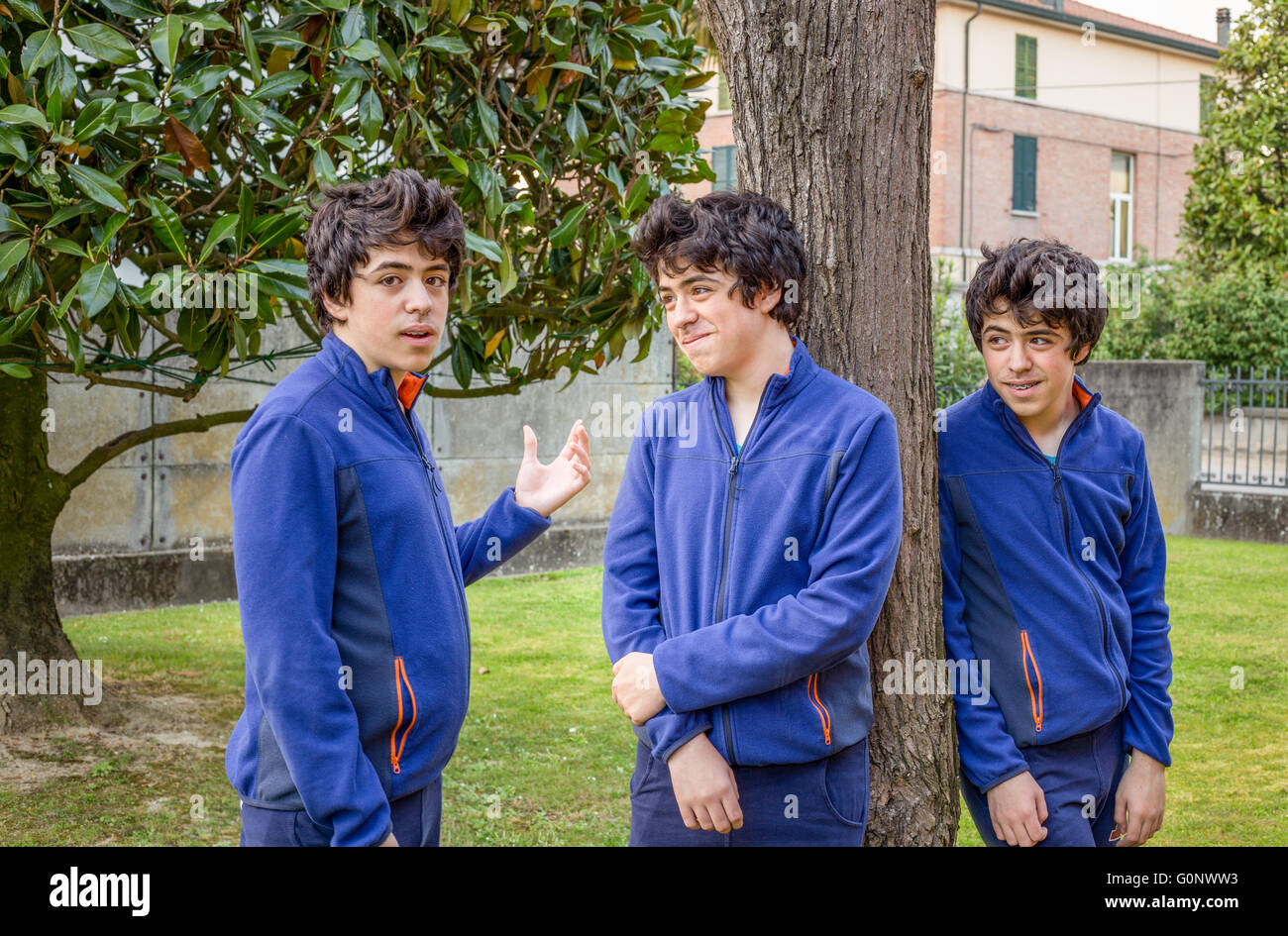 three boys talking to each other in a garden, actually the same guy in ...